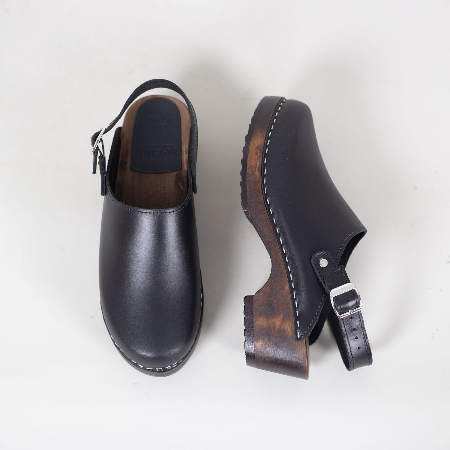 Austin clogs in black leather on brown stained and varnished comfy bottoms