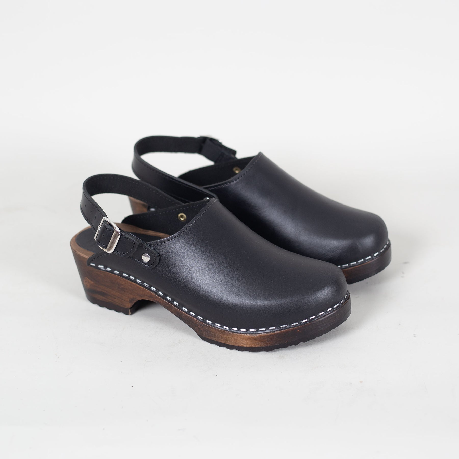 Austin clogs in black leather on brown stained and varnished comfy bottoms