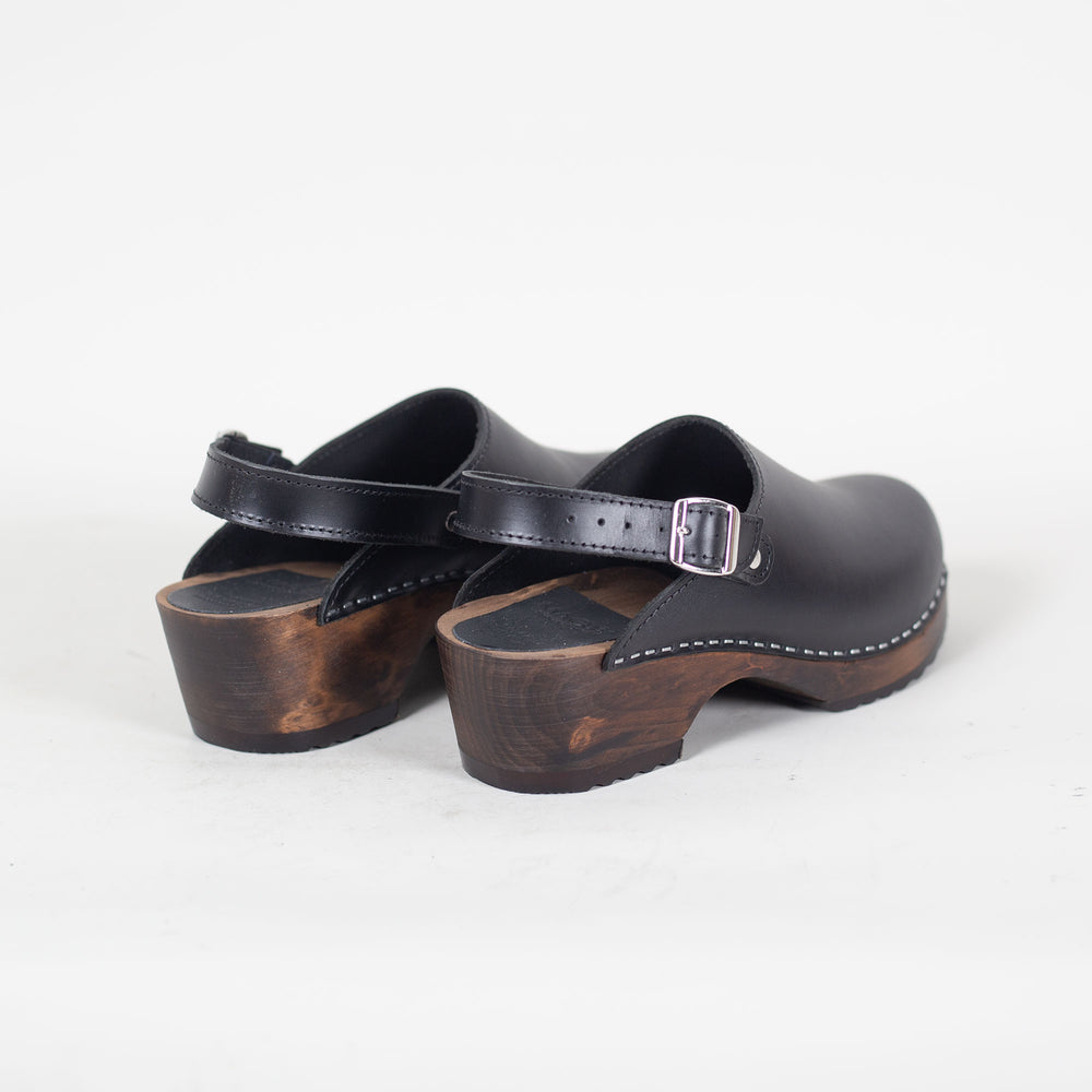 Austin clogs in black leather on brown stained and varnished comfy bottoms