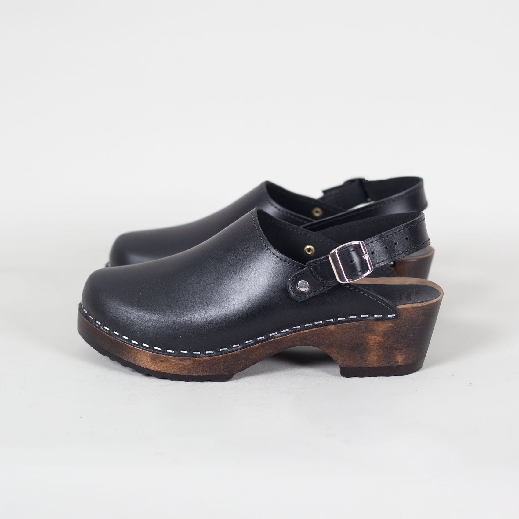 Austin clogs in black leather on brown stained and varnished comfy bottoms