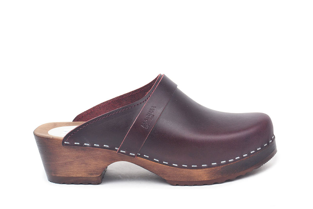 Berkeley clogs in bordeaux pull up leather on a brown wooden bottom