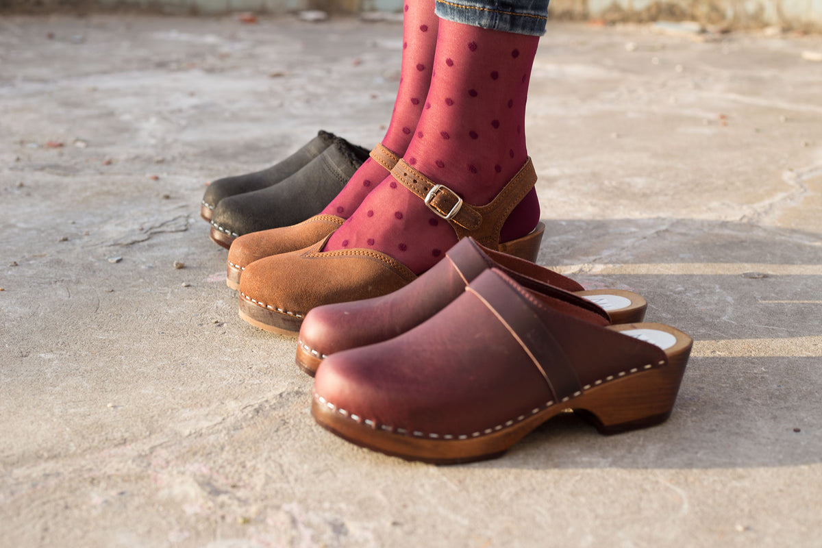 Berkeley clogs in bordeaux pull up leather on a brown wooden bottom